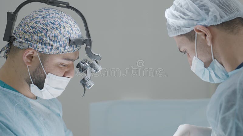 Surgeon and Assistant Perform Operation. Action. Two Qualified Surgeons ...