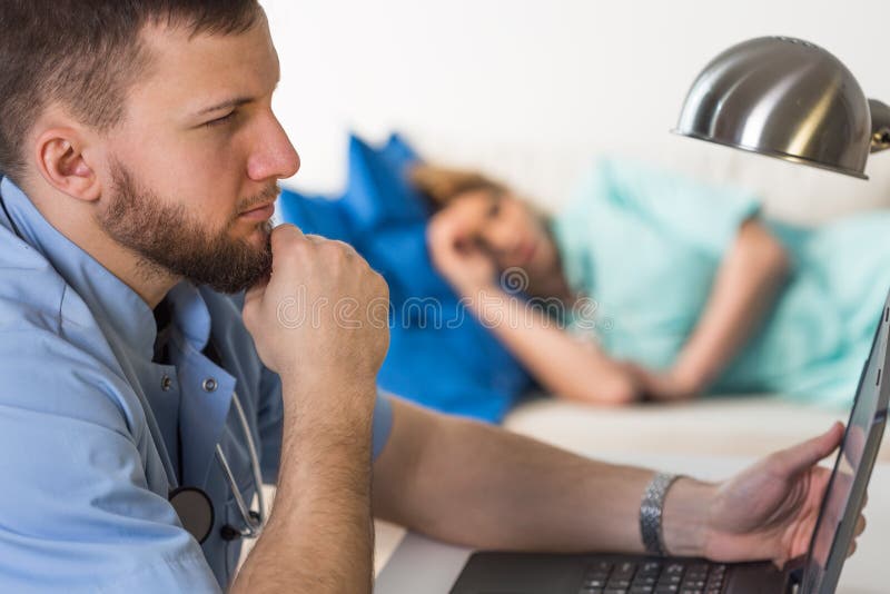 Surgeon Checking Something on Laptop Stock Image - Image of night ...