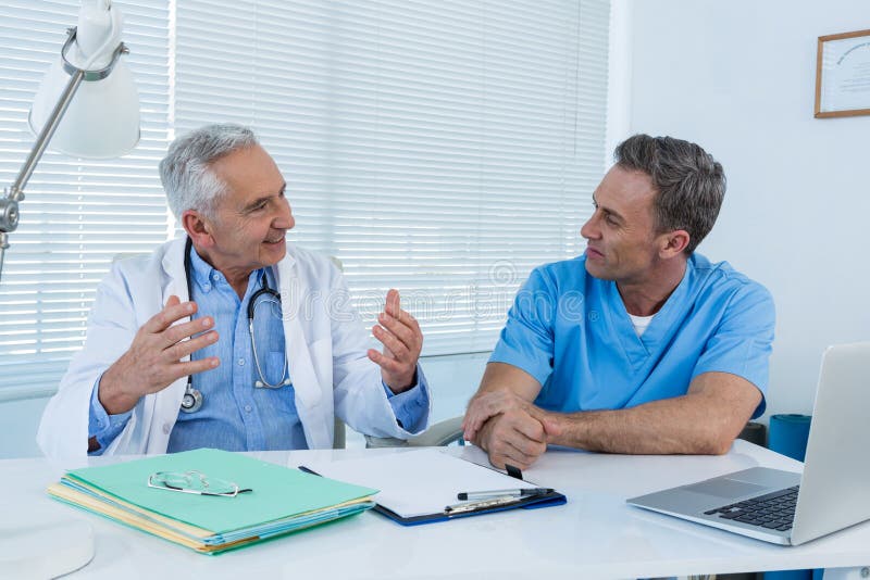 Surgeon and Doctor Interacting with Each Other Stock Photo - Image of ...