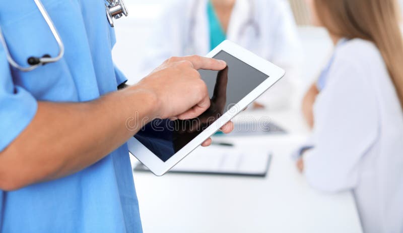 Surgeon Doctor Using Tablet Computer, Close-up of Hands at Touch Pad ...