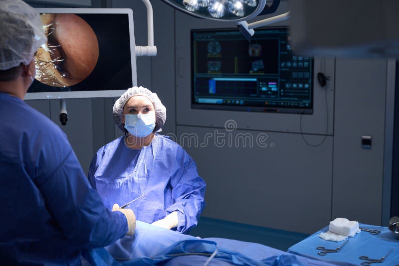 Surgeon Examining Screen during Surgery in or Stock Photo - Image of ...