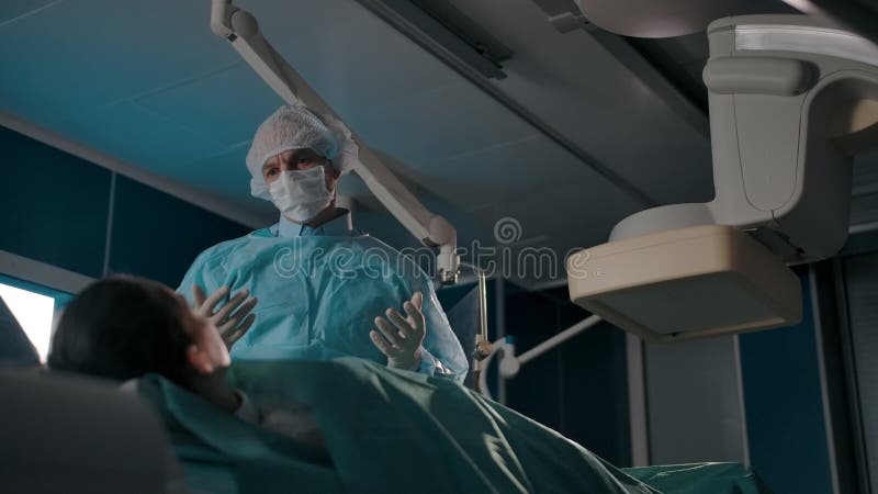Surgeon Explains Treatment Plan for Patient on Operating Table Stock ...