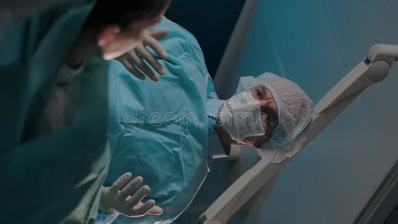 Vertical of Surgeon Explains Treatment Plan for Patient on Operating ...