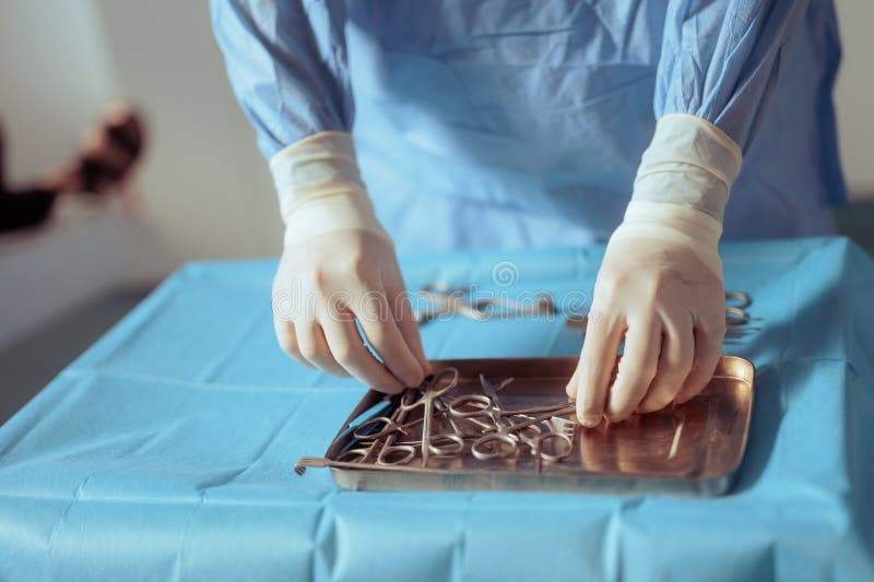 Doctor Preparing His Instruments for the Surgical Operation Stock Photo ...