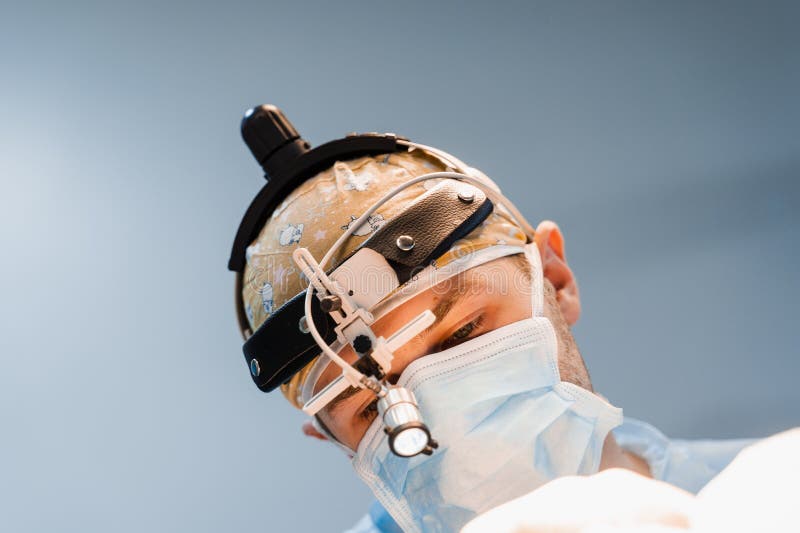 Surgeon with Headlight is Working in Operating Room. Blepharoplasty ...