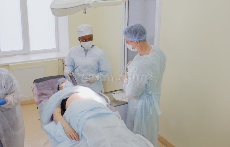 The Surgeon and His Assistant are Preparing for the Operation of a ...