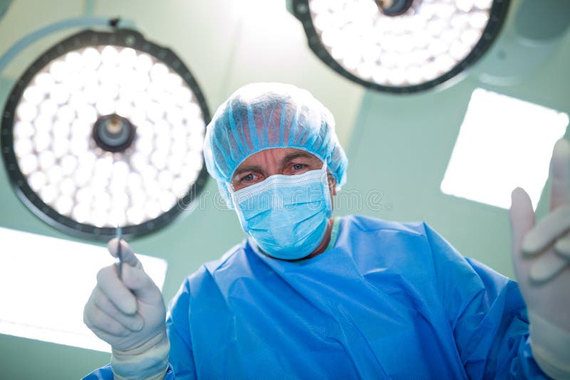 Surgeon Holding Surgical Tool in Operation Room Stock Photo - Image of ...