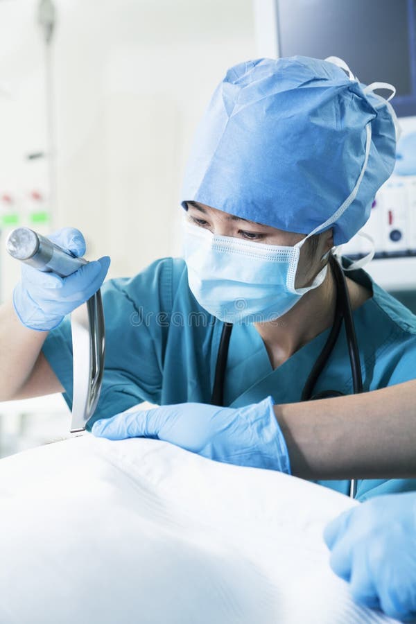 Surgeon Holding Surgical Tool in Operation Theater Stock Image - Image ...