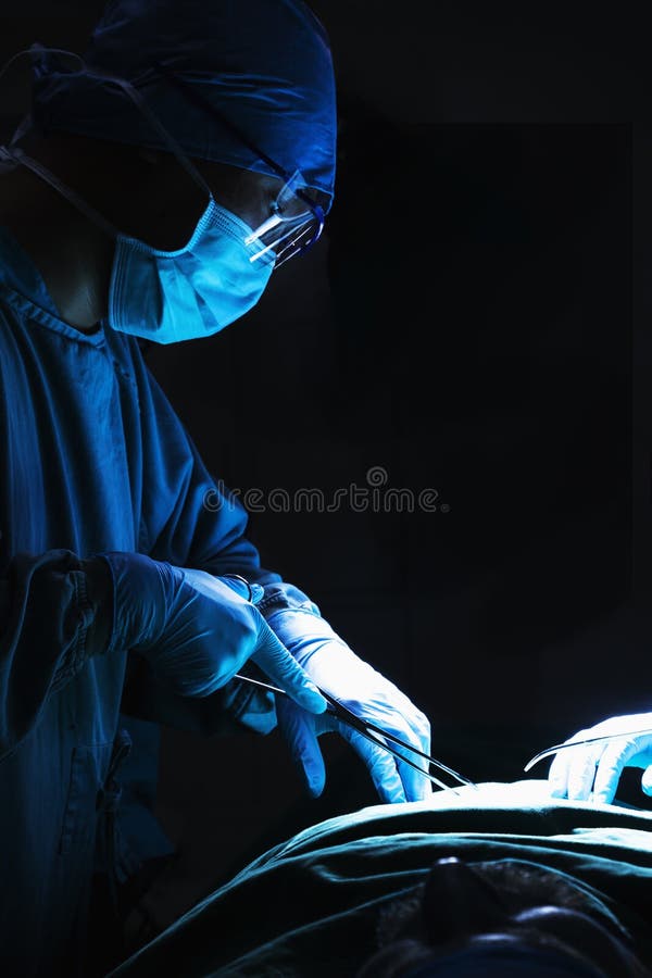 Surgeon Looking Down, Working, and Holding Surgical Equipment with ...