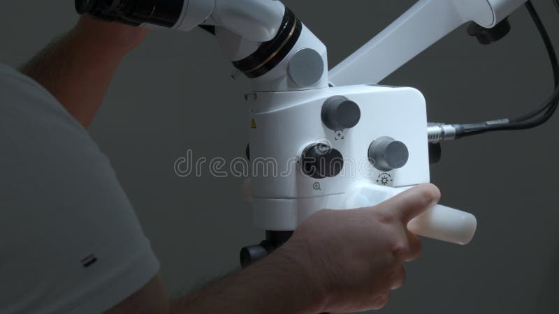 Surgeon Looking into the Microscope at the Operating Room. Action ...
