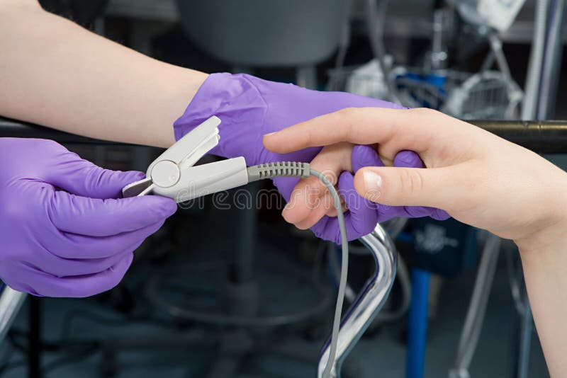 Surgeon Putting Finger Clip on Patient Stock Photo - Image of ...