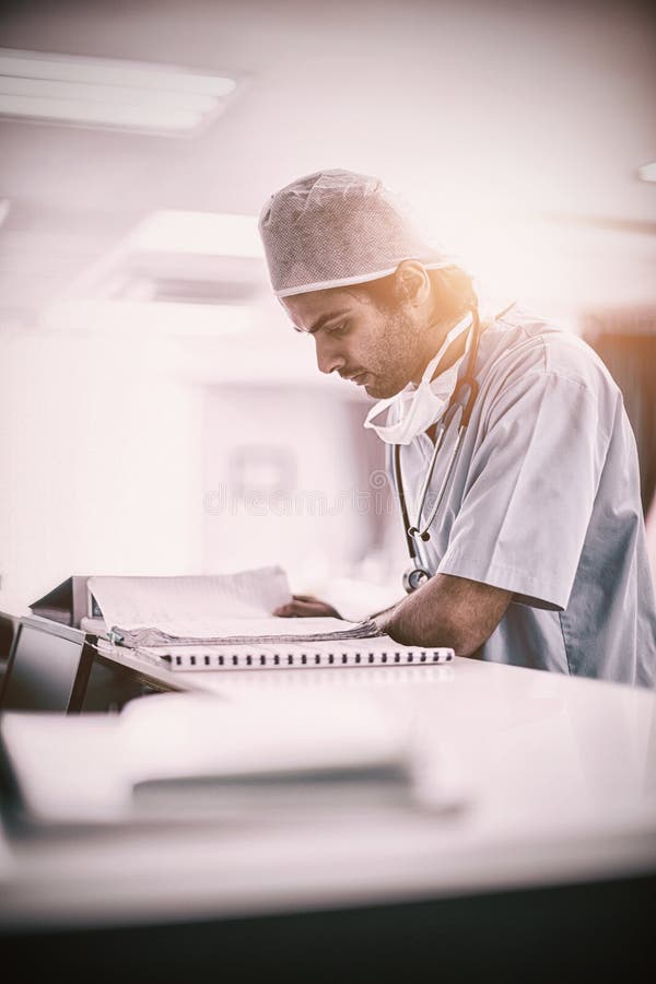 Surgeon Reading Medical Reports Stock Image - Image of expertise, male ...