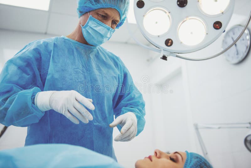 Surgeon at work stock photo. Image of lamp, mask, male - 241520982
