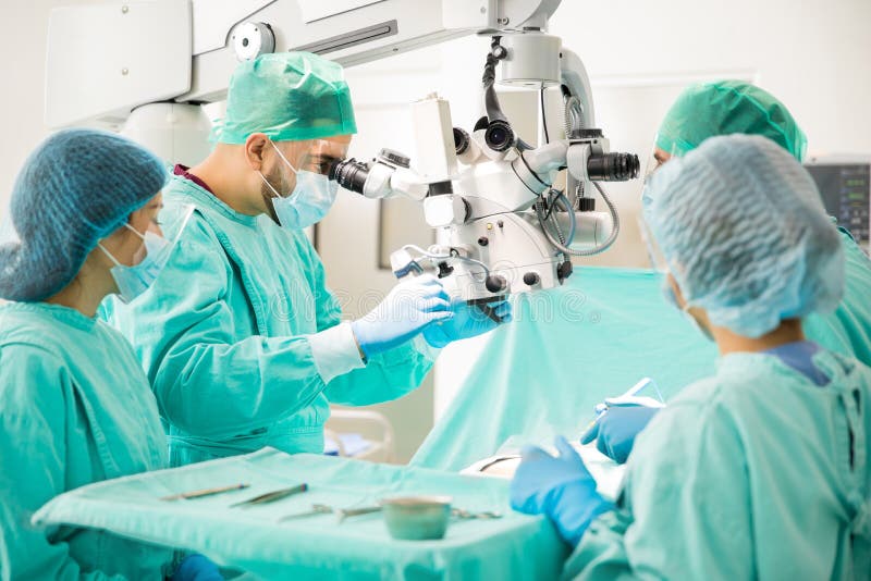 Surgeon using a microscope stock photo. Image of health - 82297496