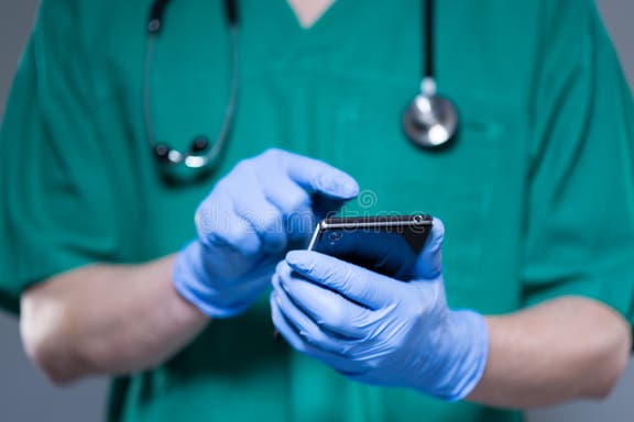 Surgeon using mobile phone stock photo. Image of doctors - 48724154