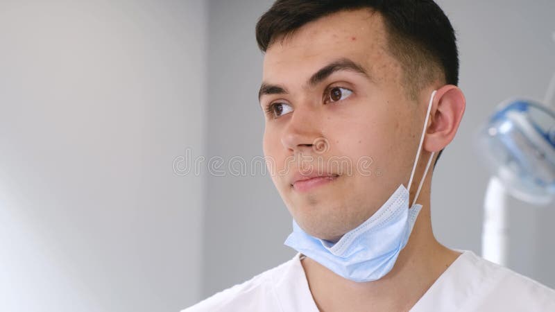 The Surgeon Wears a Protective Mask and Looks into the Camera Lens ... The Surgeon Wears a Protective Mask and Looks into the Camera Lens ...