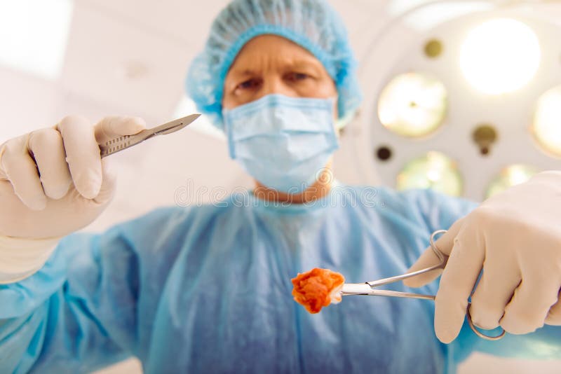 Surgeon at work stock image. Image of instrument, assistance - 69371675