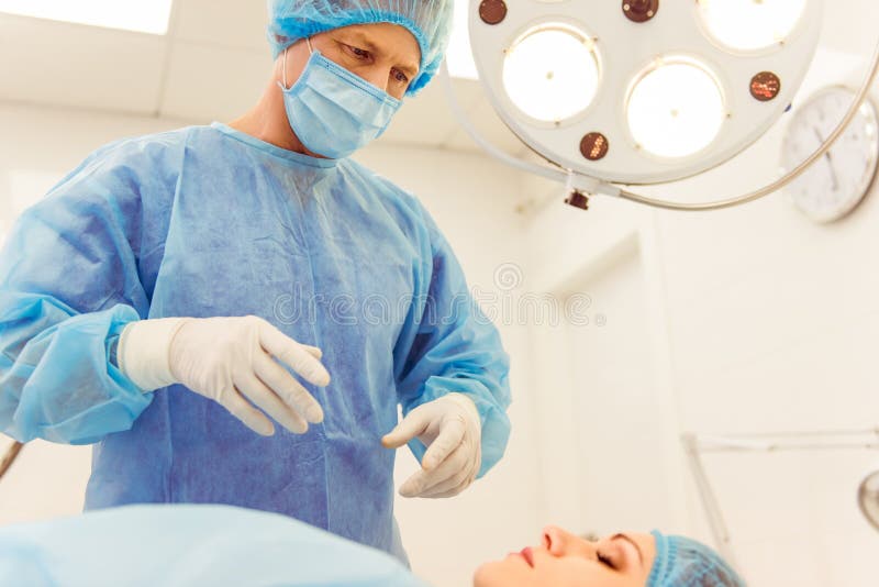 Surgeon at work stock photo. Image of male, mask, looking - 69372872