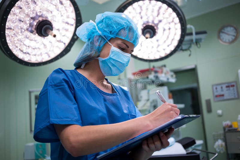 Surgeon Writing on Clipboard in Operation Room Stock Photo - Image of ...