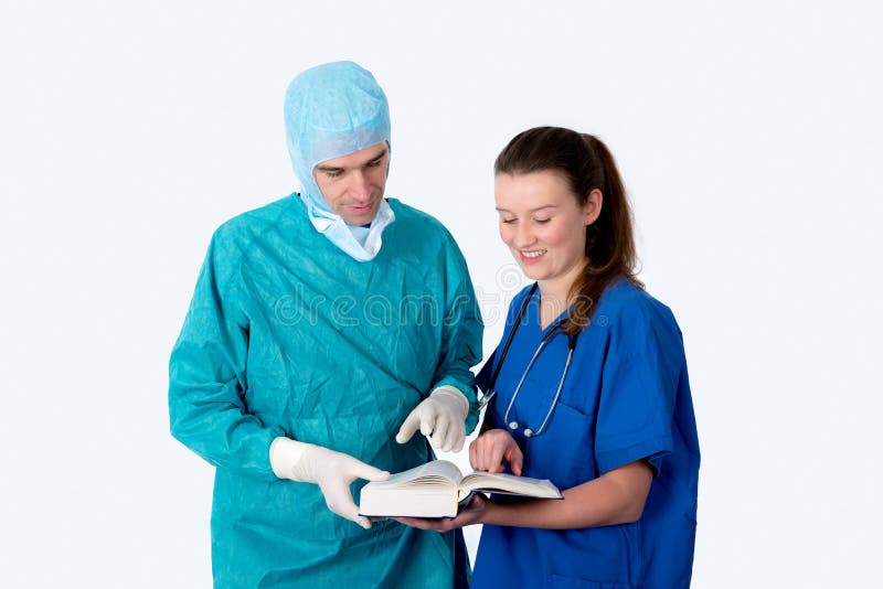 Surgeon and Young Female Doctor Reading a Book Stock Image - Image of ...
