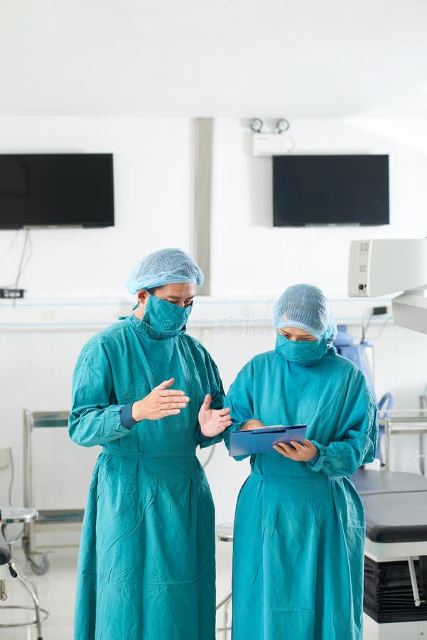 Surgeons Discussing Document Stock Image - Image of medicine, surgery ...