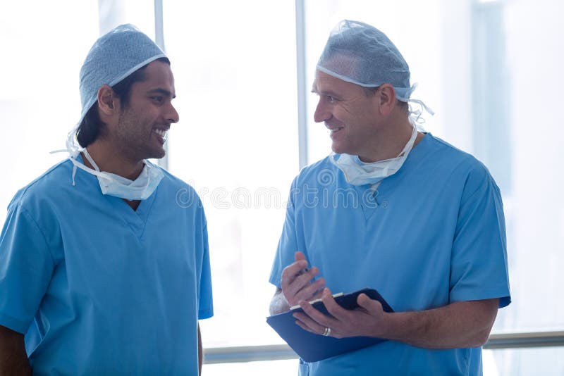 Surgeons Discussing Over Medical Reports Stock Photo - Image of medical ...