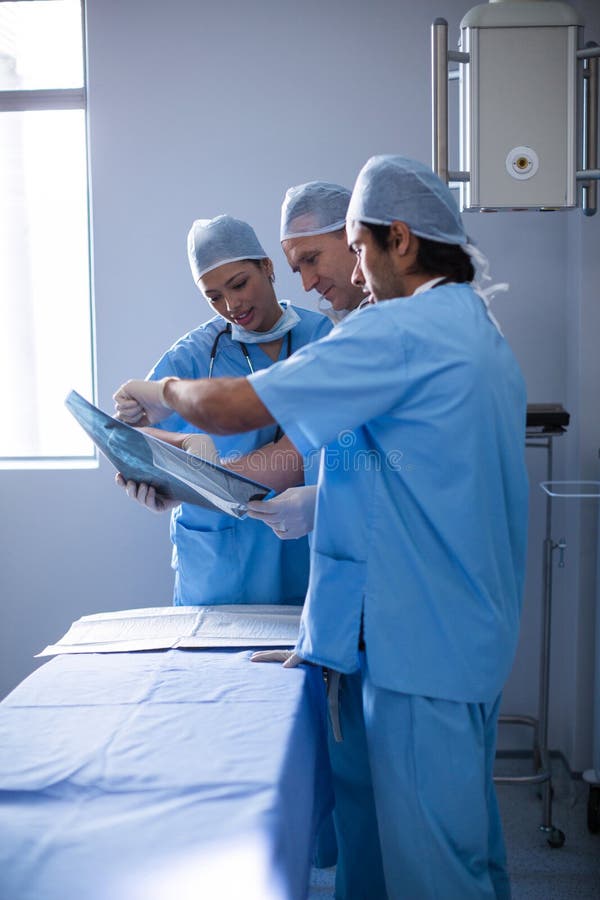 Surgeons Discussing Over X-ray Stock Photo - Image of medical ...