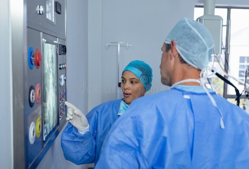 Surgeons Discussing Over X-ray Report on X-ray Light Box in Operating ...