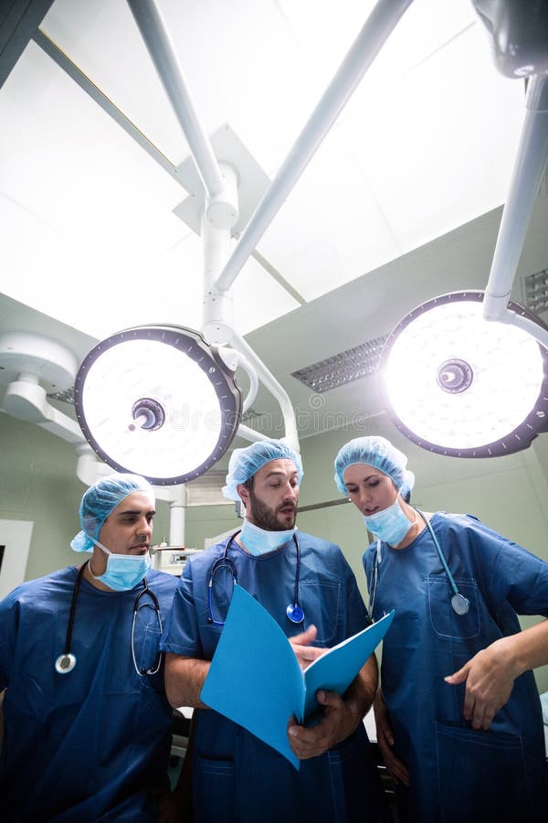 Surgeons Discussing Patient Records in Operation Room Stock Image ...