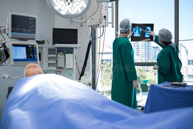 Male Surgeon Consoling Patient in Operation Theater Stock Image - Image ...