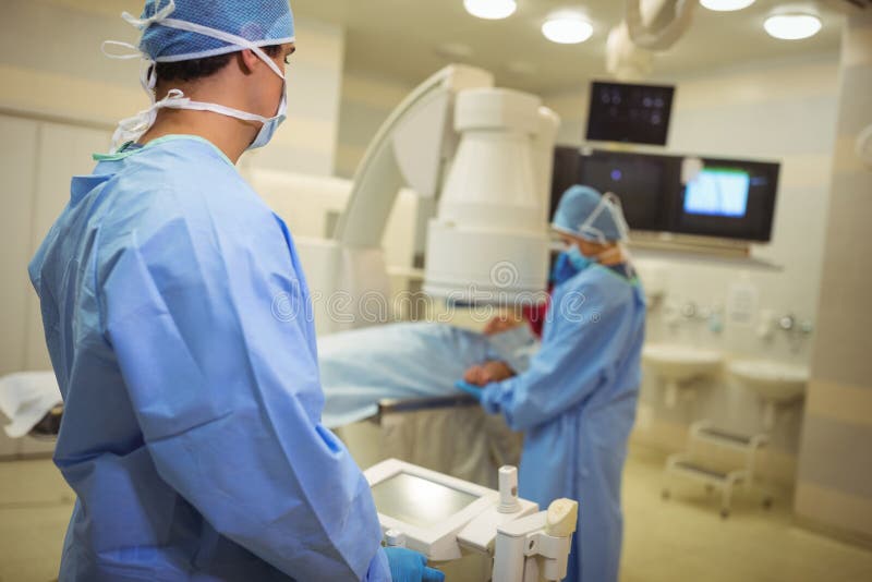 Surgeons Examining Patient in Operation Theater Stock Photo - Image of ...