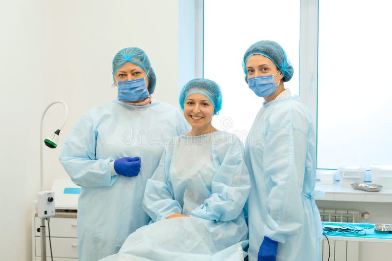 Surgeons and Happy Patient after Successful Surgery To Remove a Mole on ...