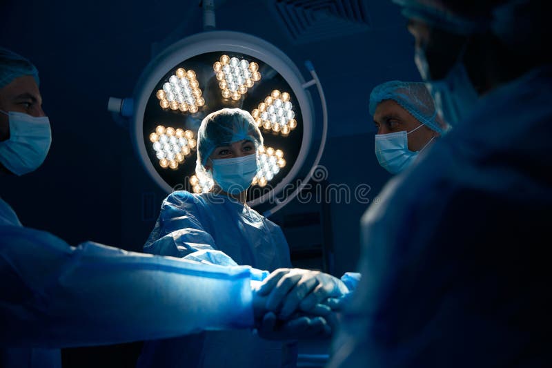 Surgeons Holding Hands while Preparing for Operation in Operating Room ...