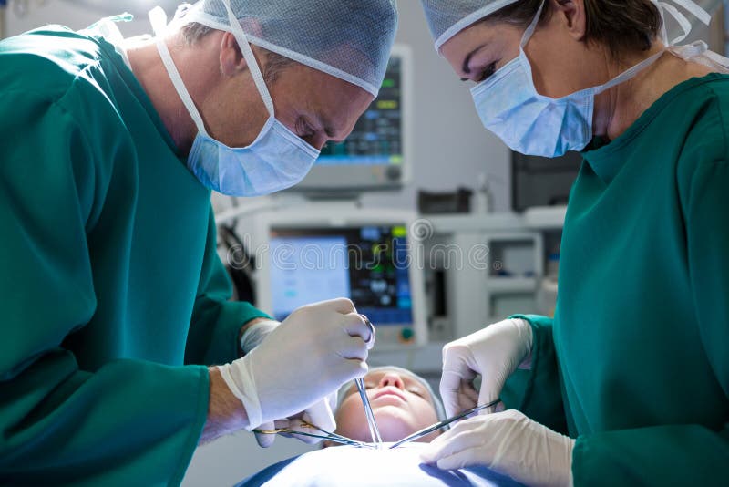 Surgeons operating patient stock image. Image of adult - 81404599