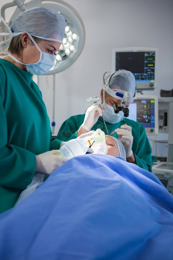 Surgeons operating patient stock photo. Image of health - 81455484