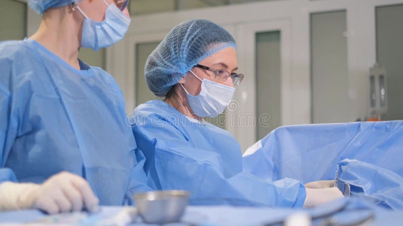 Surgeons Perform a Complex Operation on an Elderly Woman on the ...