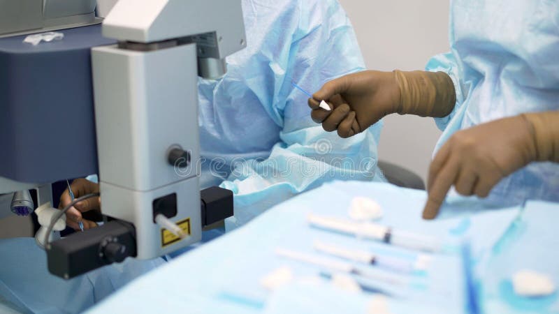 Surgeons Performing Laser Eye Surgery Using a Surgical Microscope Stock ...