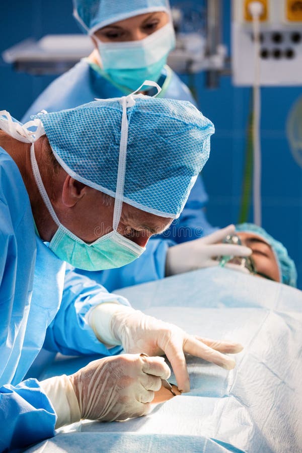 Surgeons Performing Operation in Operation Room Stock Photo - Image of ...