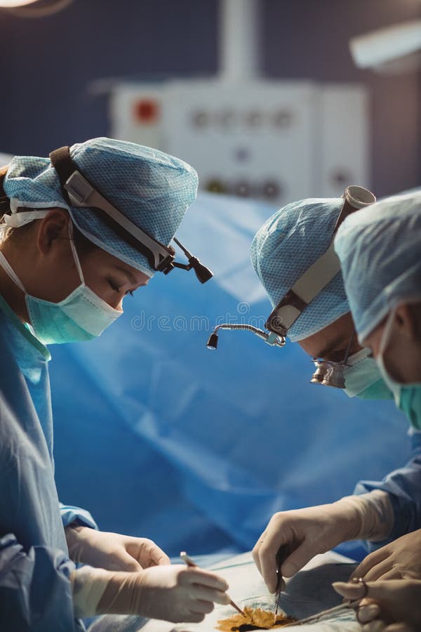 Surgeons Performing Operation in Operation Room Stock Photo - Image of ...