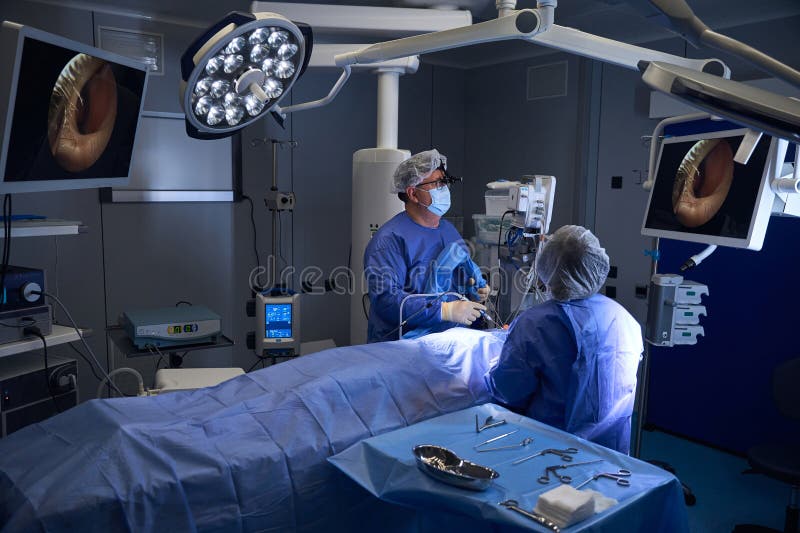 Surgeons Preparing Instruments during Surgery in or Stock Image - Image ...
