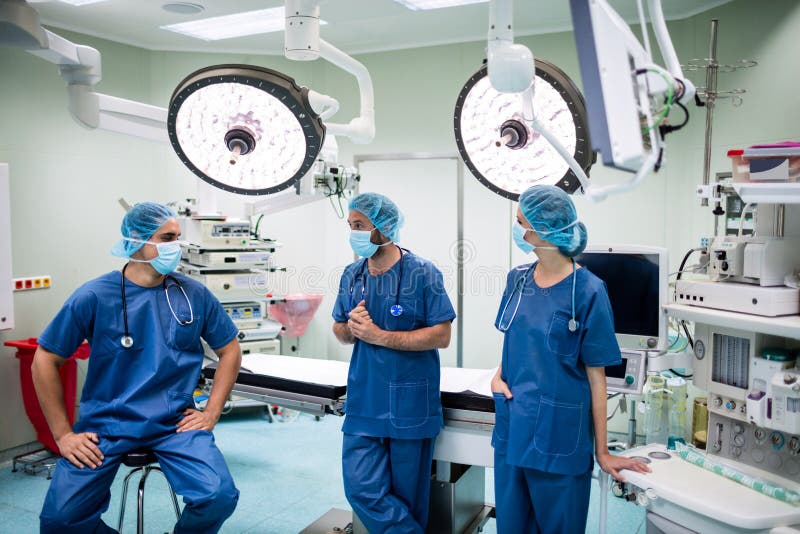 Two Surgeons Talking in Operating Room Stock Photo - Image of hospital ...