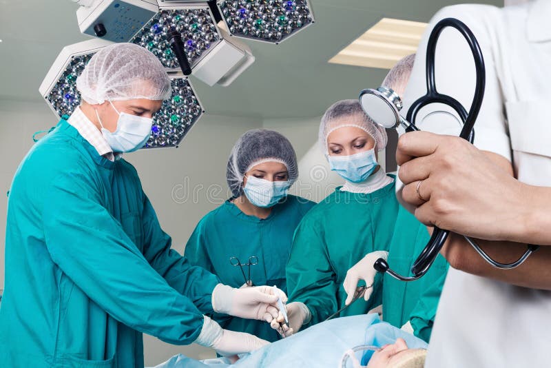 Surgeons Team during a Surgery Stock Photo - Image of assistant, mask ...