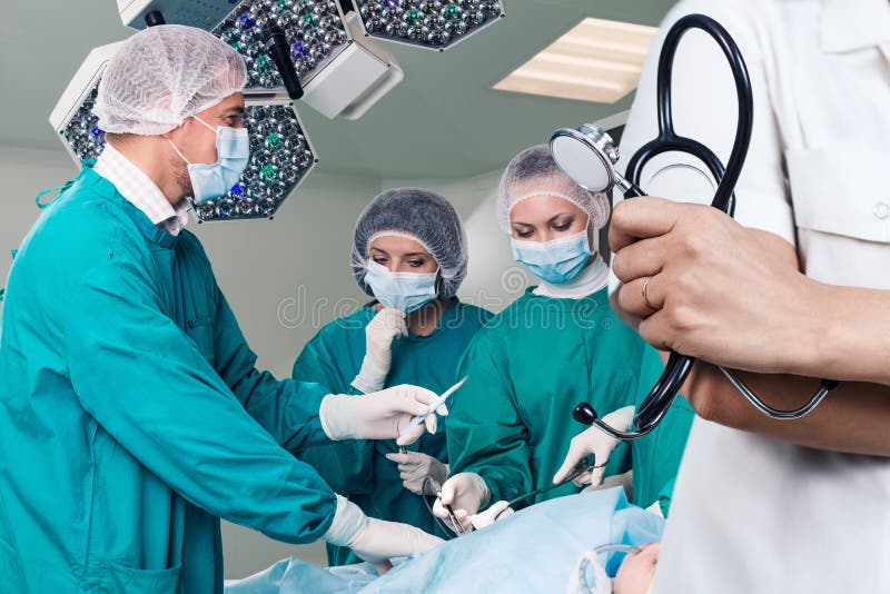 Surgeons Team during a Surgery Stock Photo - Image of practitioner ...