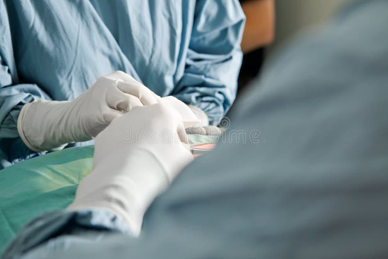 A Team of Urologist Doctors Performing a Cystoscopy Using a Cystoscope ...