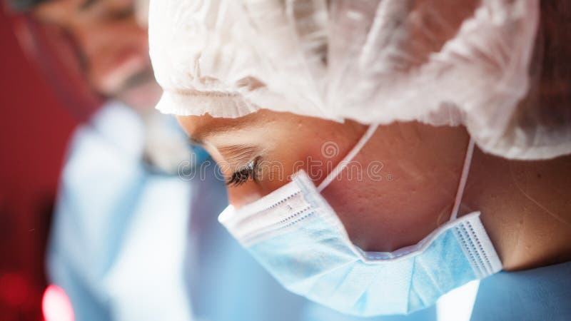 Surgery during a red alert stock photo. Image of mask - 316512322