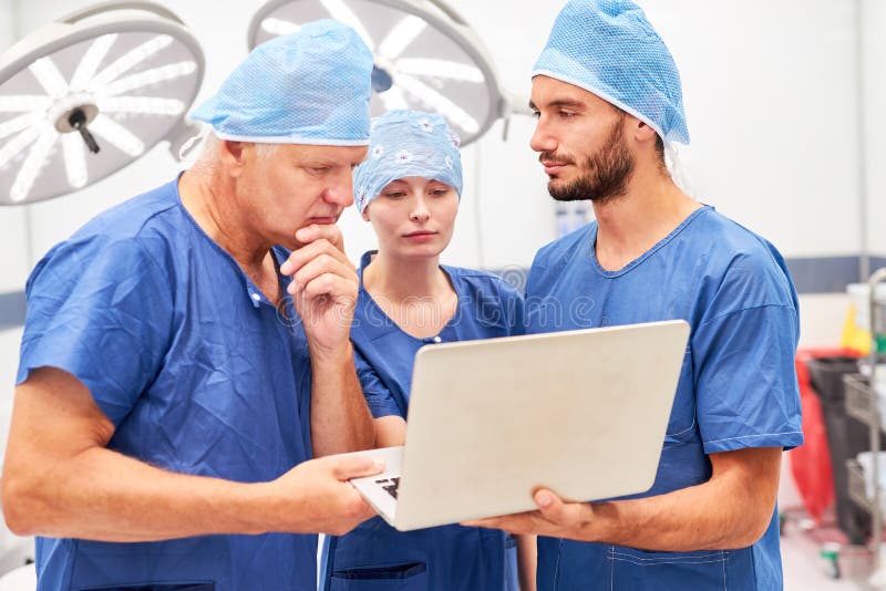 Surgery Team Performing an Operation on a Patient Stock Image - Image ...