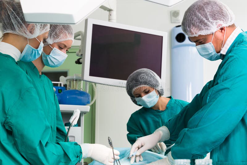 Multi-ethnic Surgeons during a Surgery Stock Image - Image of ailment ...