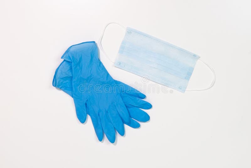 Surgical Face Mask and Blue Nitrile Gloves on White Table. PPE for ...