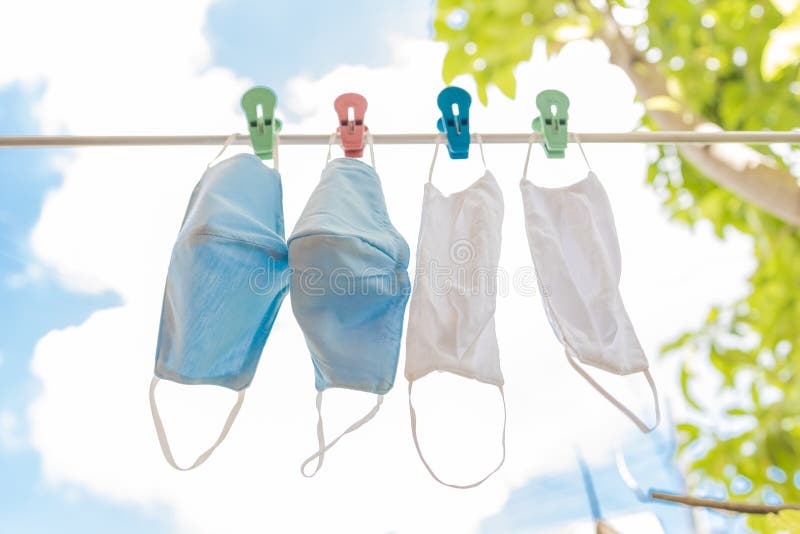 Surgical Face Masks Drying in Sun on a Rope with Blue Sky in Background ...