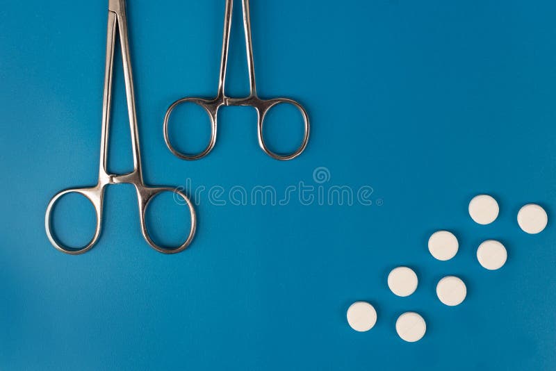 Surgical Instrument and Medical Capsules on a Blue Background Stock ...